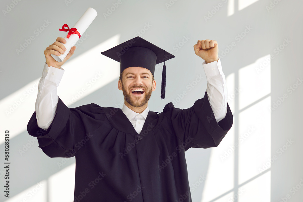Male student having fun on graduation day. Happy university or college ...