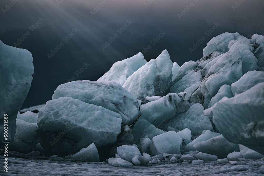 Sunlight highlights blue icebergs in the Jokulsarlon glacial lagoon ...