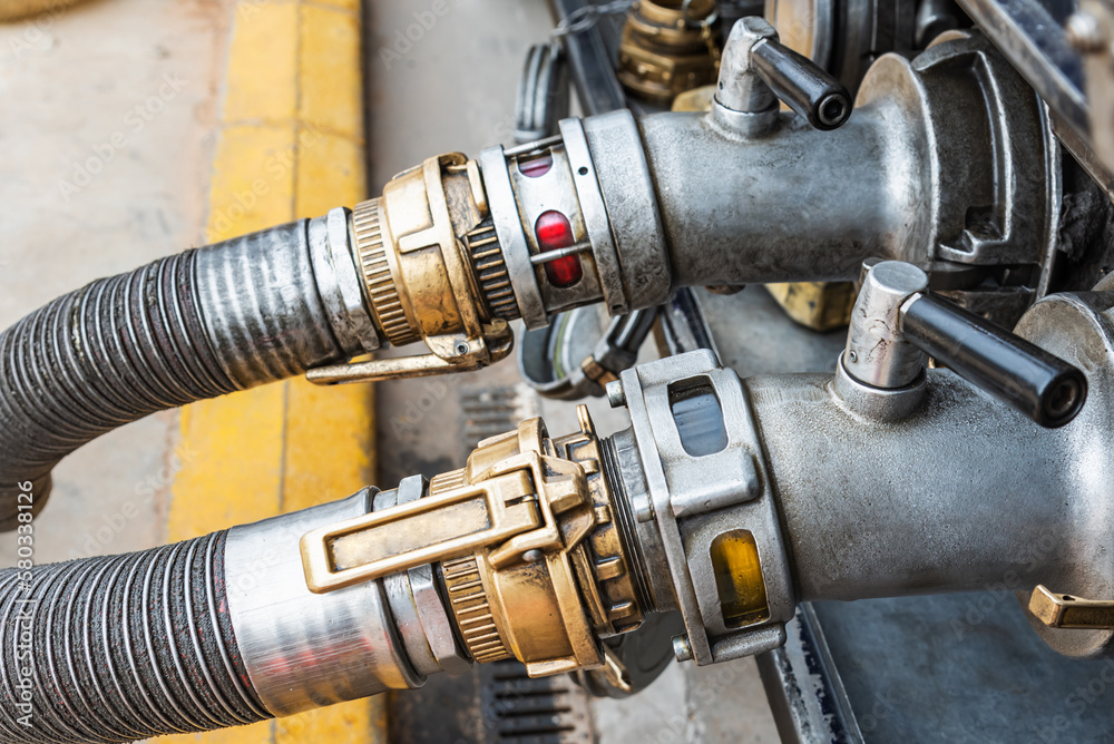 Devices attached to the mouths of a tanker truck to connect the ...