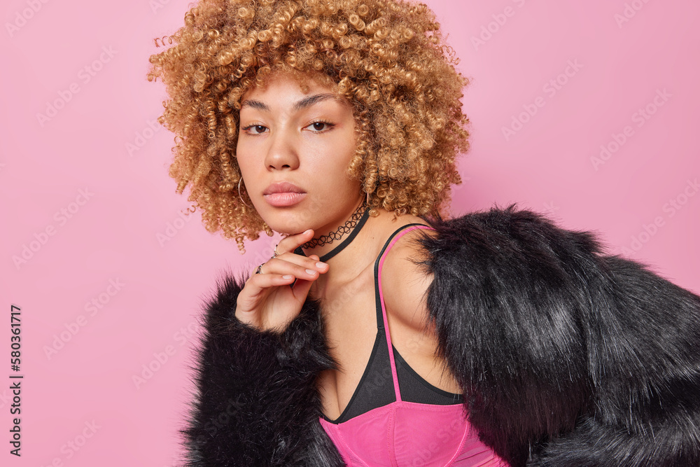 Horizontal Shot Of Serious Determined Woman Looks Directly At Camera