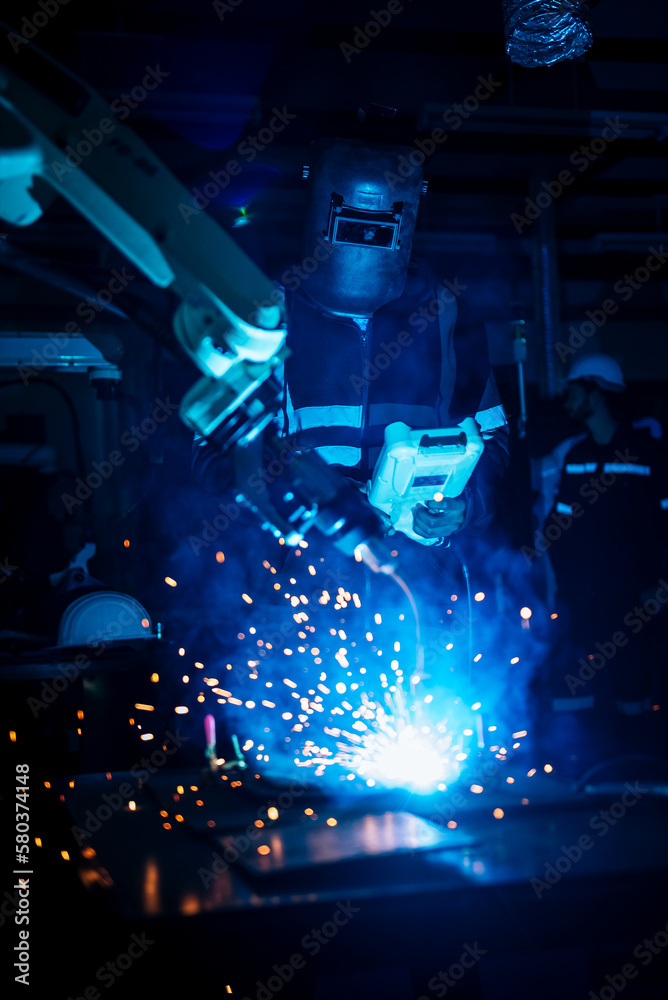 Specialist robotic engineers maintenance and control robot arm in ...