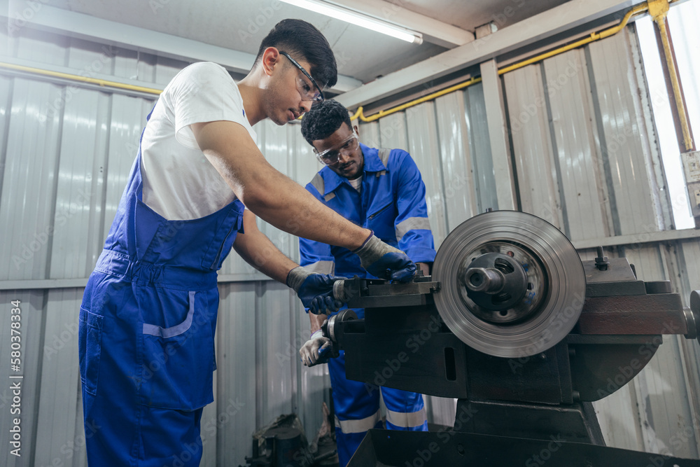 Diversity mechanic worker or metalworker using metal lathe machine ...