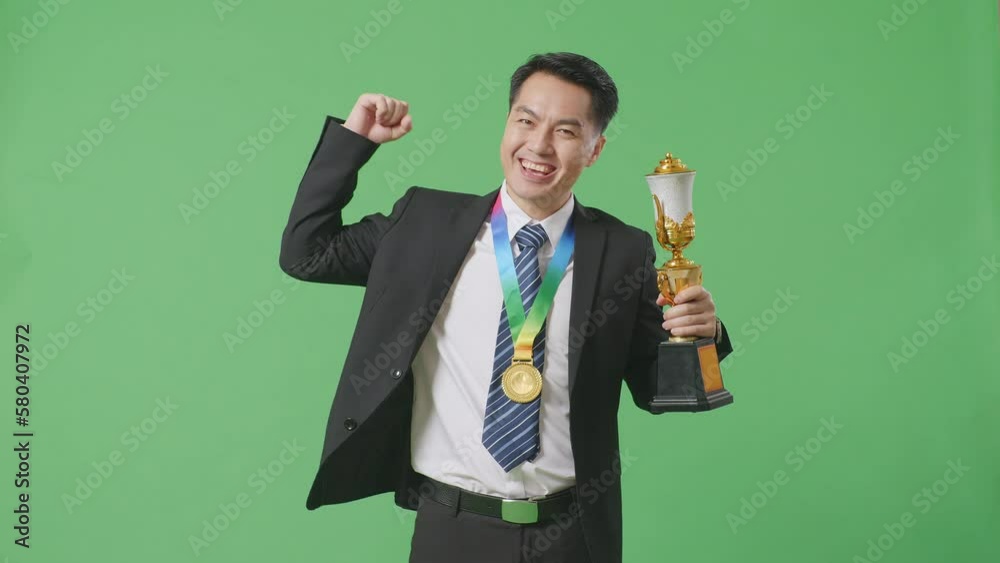 Asian Business Man In A Suit And Tie With A Gold Medal And Trophy ...
