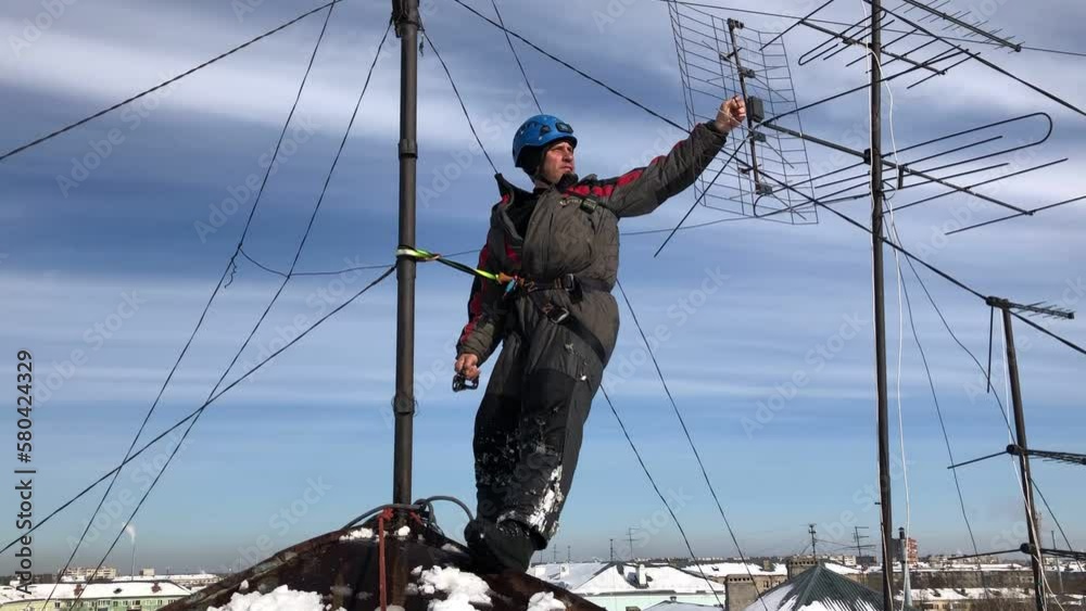 Installer high-rise rope access. Roof climber with antenna. Rope access ...