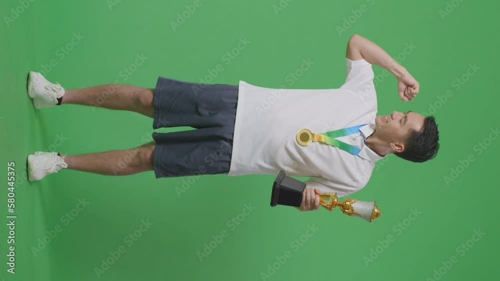 Full Body Of Asian Man With A Gold Medal And Trophy Flexing His Bicep ...