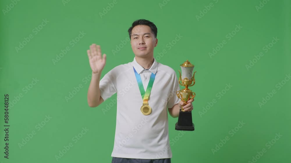 Asian Man With A Gold Medal And Trophy Waving His Hand And Smiling To ...