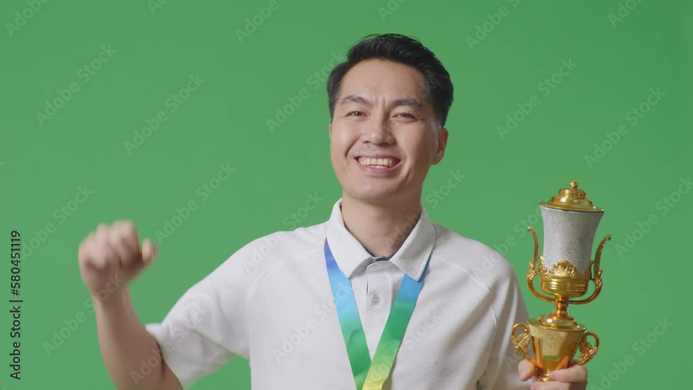 Close Up Of Asian Man With A Gold Medal And Trophy Flexing His Bicep ...
