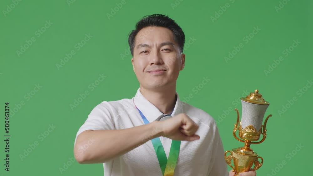 Close Up Of Asian Man With A Gold Medal And Trophy Touching His Chest ...