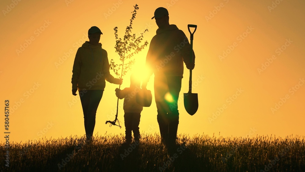 Farmer dad, mom child planting tree. Happy family team planting tree in ...