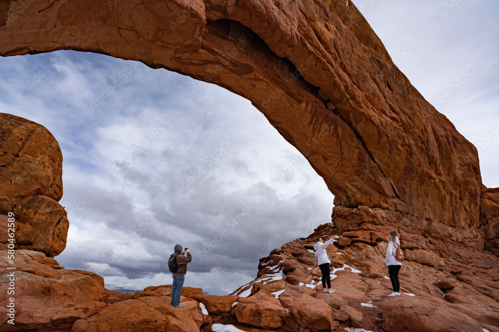 Family hiking in red mountains in Utah. Friends walking under North ...