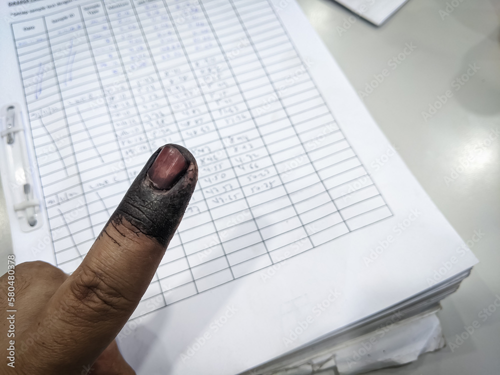 Index finger with indelible ink stain after voting in election with ...