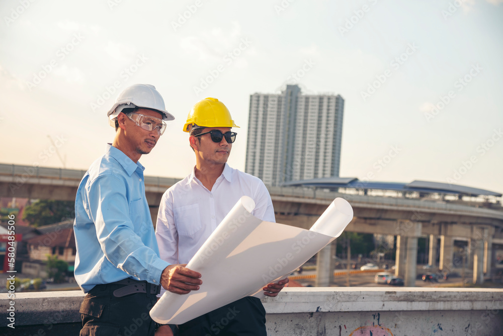 Two men engineer look at blueprint architecture building contractor ...