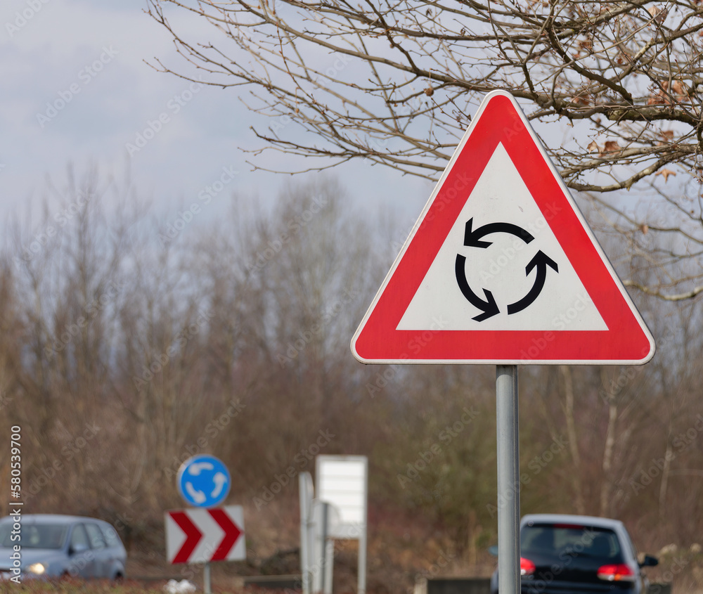 Close-up photo of a yield and roundabout traffic sign attached to a ...