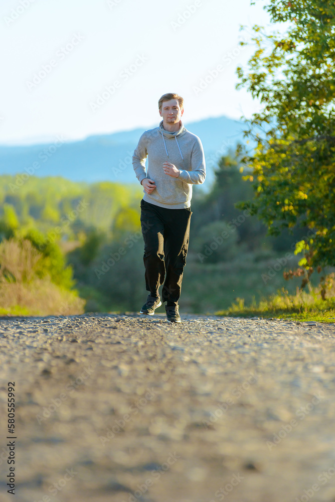 Running man jogging in rural nature at beautiful summer day. Sport ...
