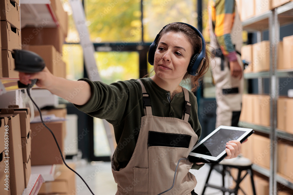 Supervisor wearing headset listening music during inventory in ...