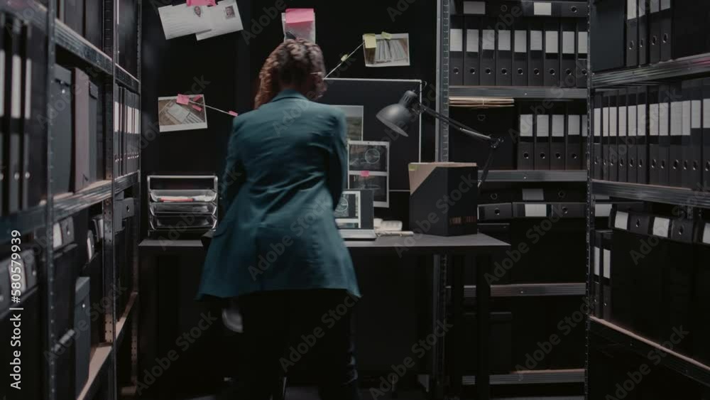 Private inspector examining clues and records, conducting criminal ...