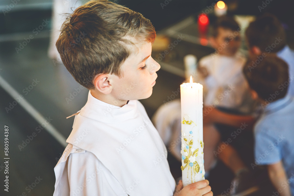 Little kid boy receiving his first holy communion. Happy child holding ...