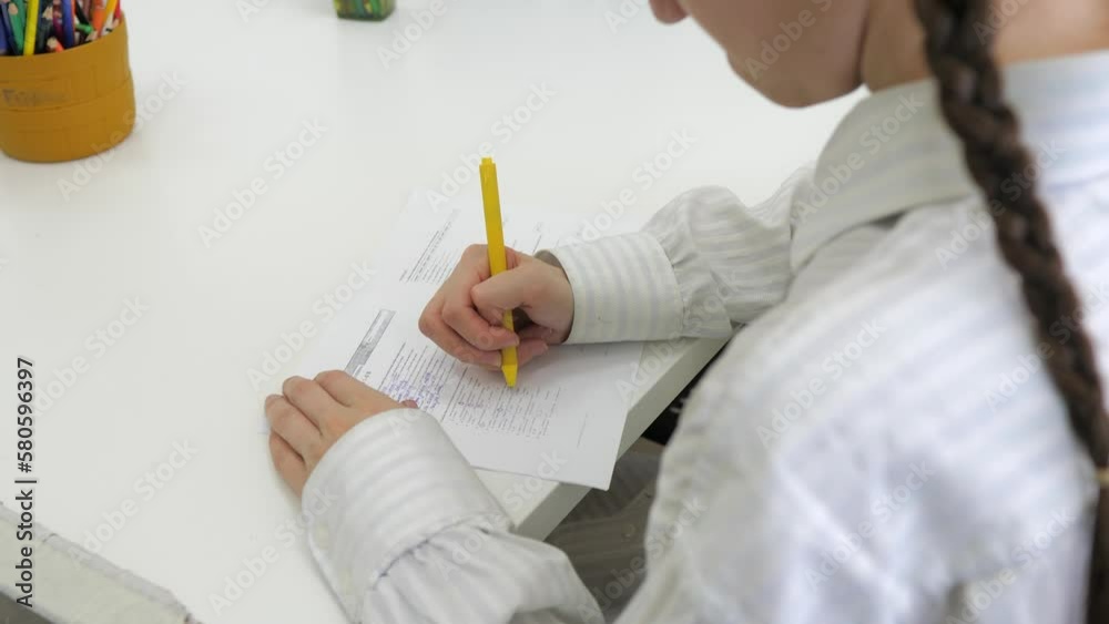 Closeup top view of child write in notebook. Little kid girl student ...