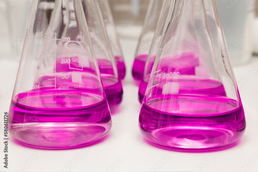 Flasks with liquid colored pink. Chemical analysis, organic test of ...