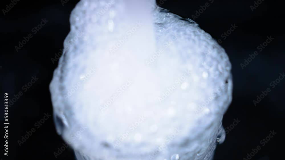 Clean drinking water from the tap. Glass of water close-up, slow motion ...