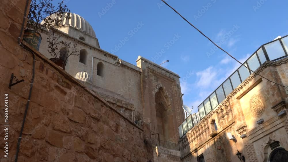 The camera scans up the stairs leading to Zinciriye Madrasa and shows ...