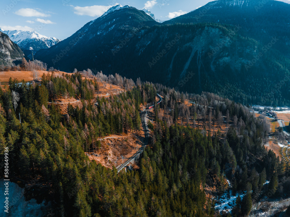 Aerial view of Train passing through famous mountain in Filisur, Switzerland. Landwasser Viaduct ...