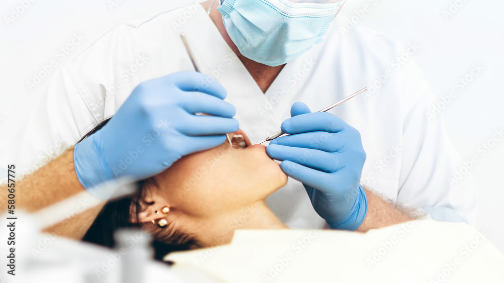Dentist with patient in dental chair providing manipulations in oral ...