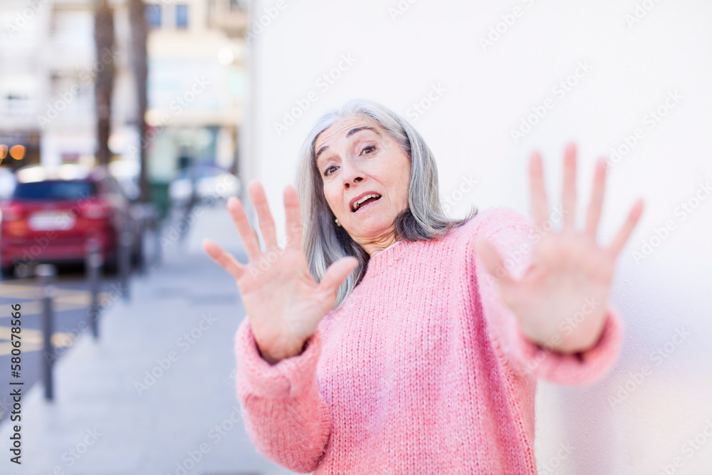 senior retired pretty white hair woman feeling terrified, backing off ...