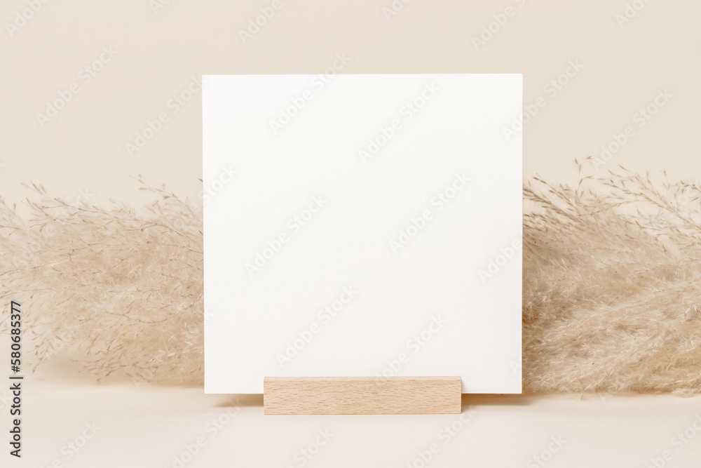 Blank paper sheet card standing with pampas grass, pastel beige ...
