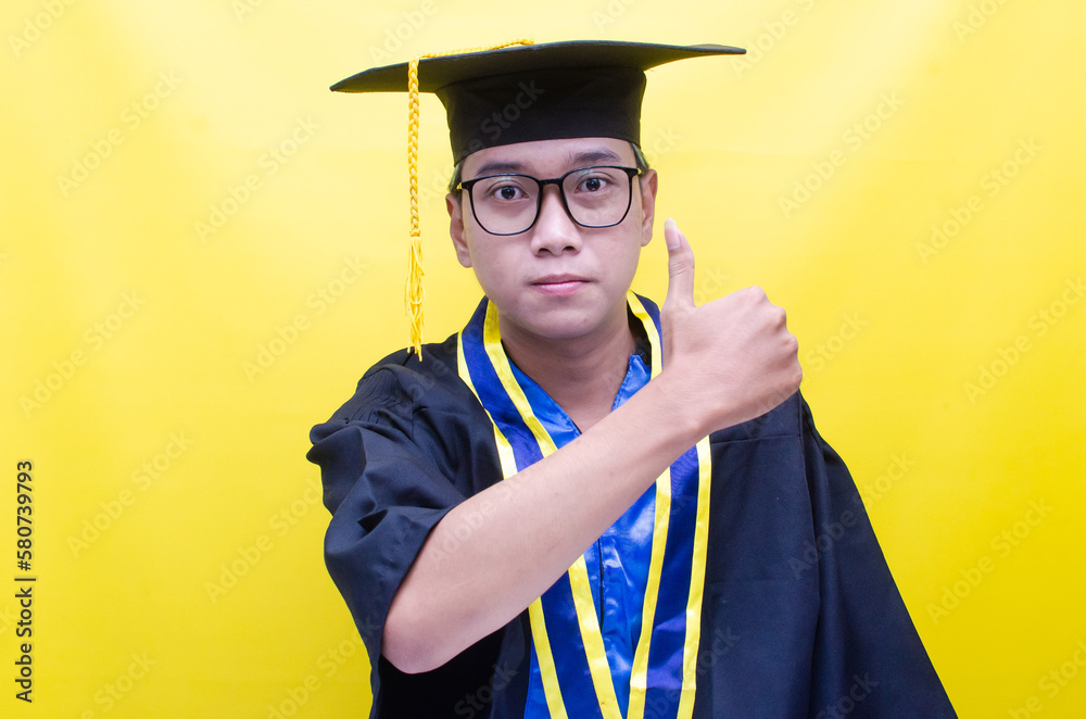asian young man gives thumbs up and shouts happily to celebrate his ...