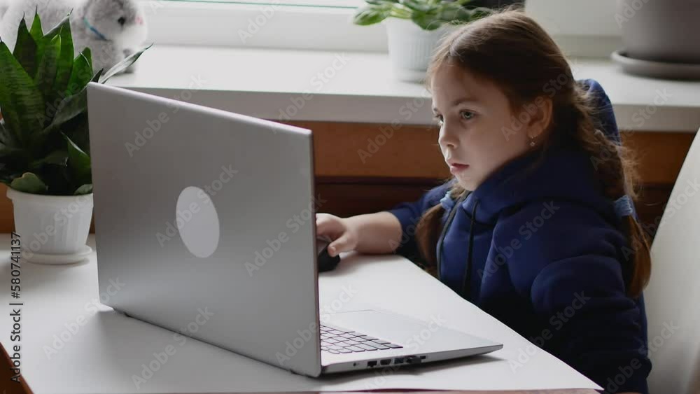 Portrait of a little girl in a blue suit with big eyes looking at a ...