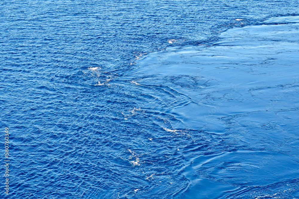Pattern formed by swirling water in the sea from the propellers of a ...