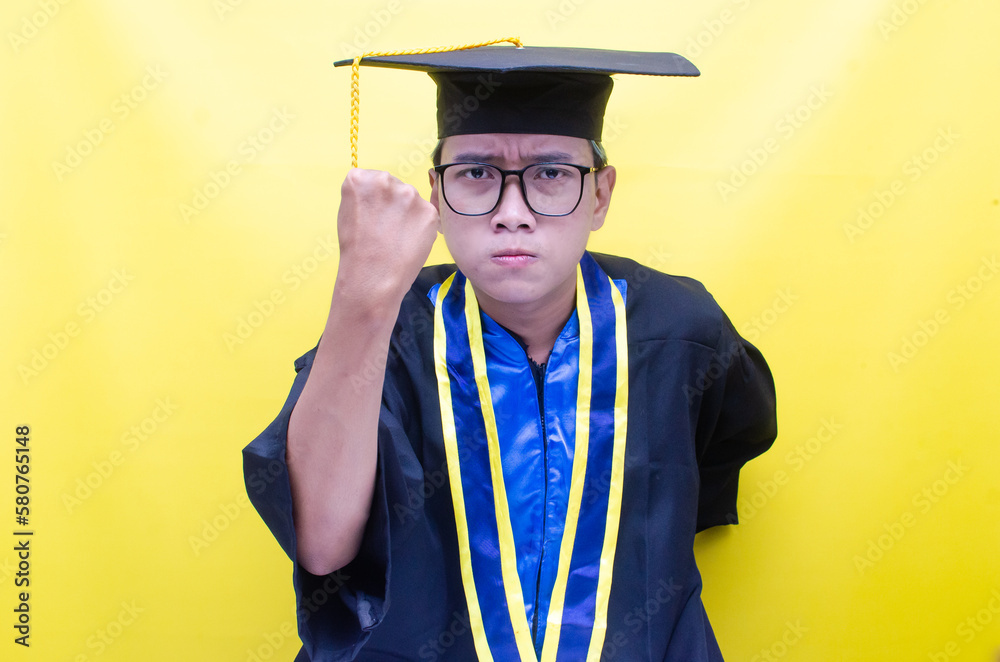 Poster angry Asian man in graduation cap and gown shouting madly and ...