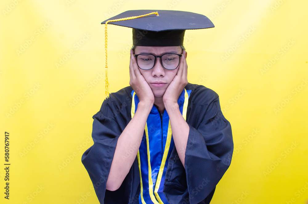 sad Asian man in graduation cap and gown rubbing his tears. student ...