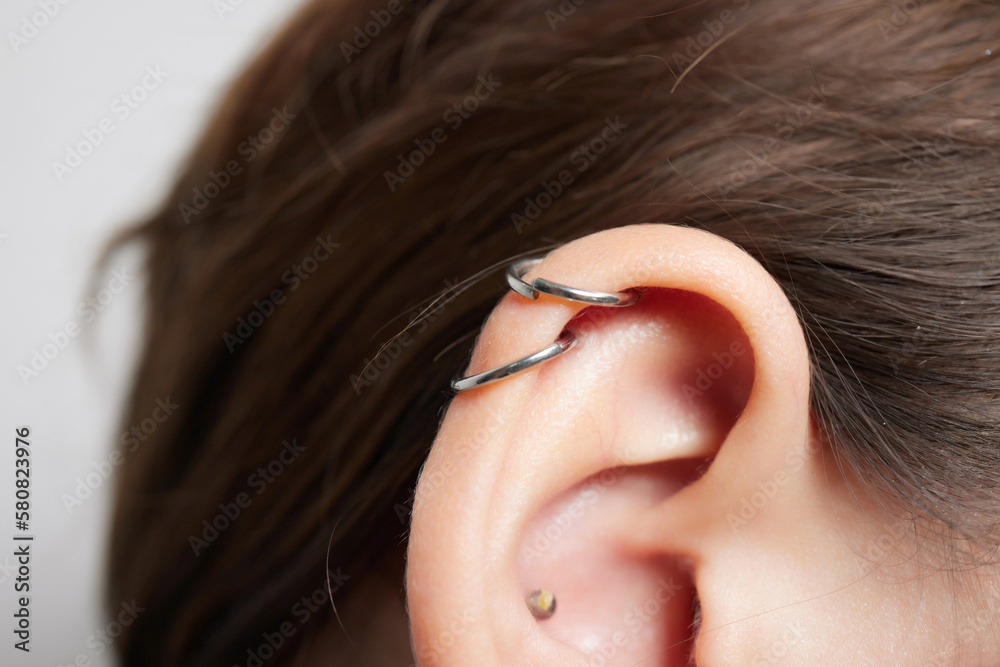 Stretched lobe piercing, grunge concept. Pierced woman ear with black ...