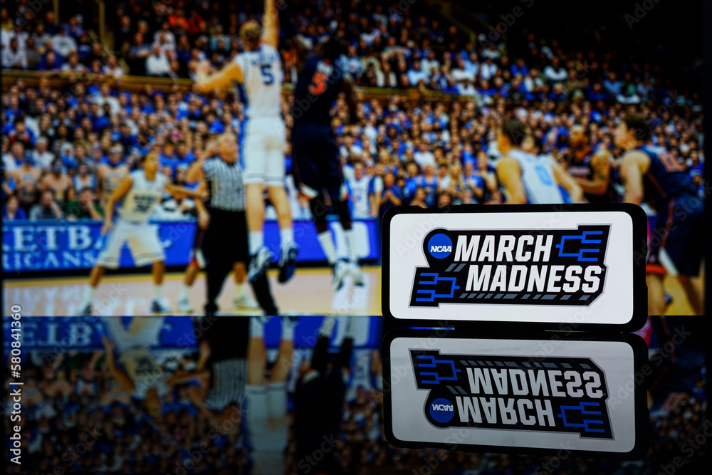 March madness logo on screen and NCAA basketball game play on TV in the ...