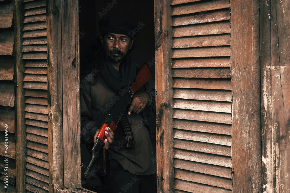 man in military outfit warrior Mujahedin,with hand holding rifle ...