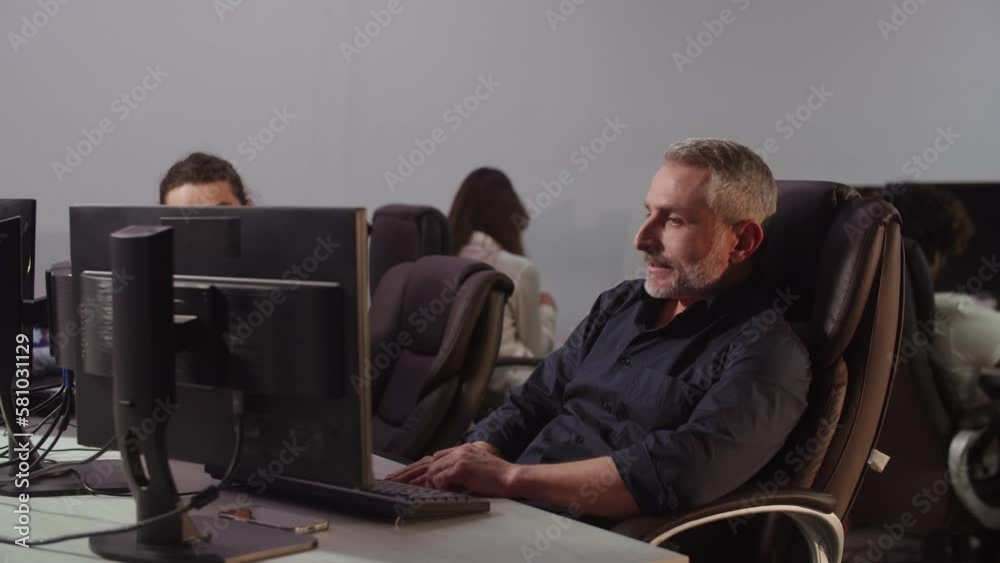 An employee of an IT company leans back in his chair and raps on the ...