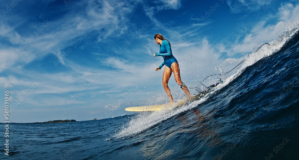 Slim woman surfer rides the wave. Woman surfs the ocean wave in the ...