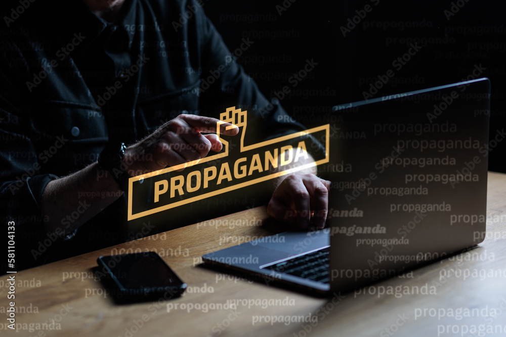 Propaganda visual concept. Man points finger at Propaganda text Stock ...