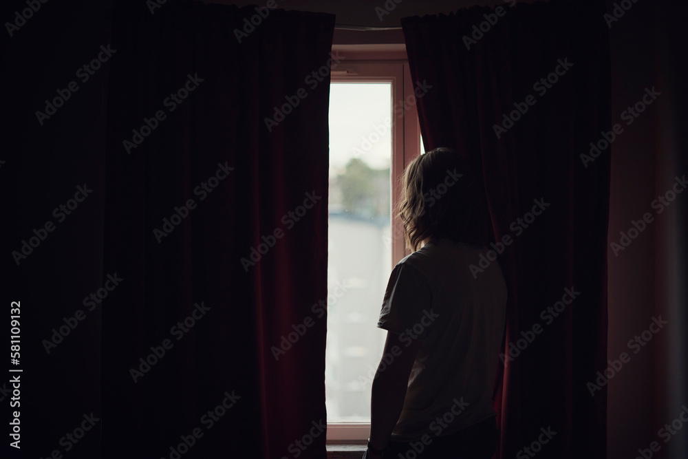 Silhouette of person looking through window Stock Photo | Adobe Stock