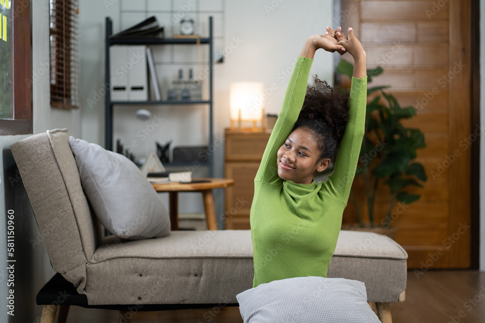 Young calm black woman relaxing in modern living room, lazy happy ...
