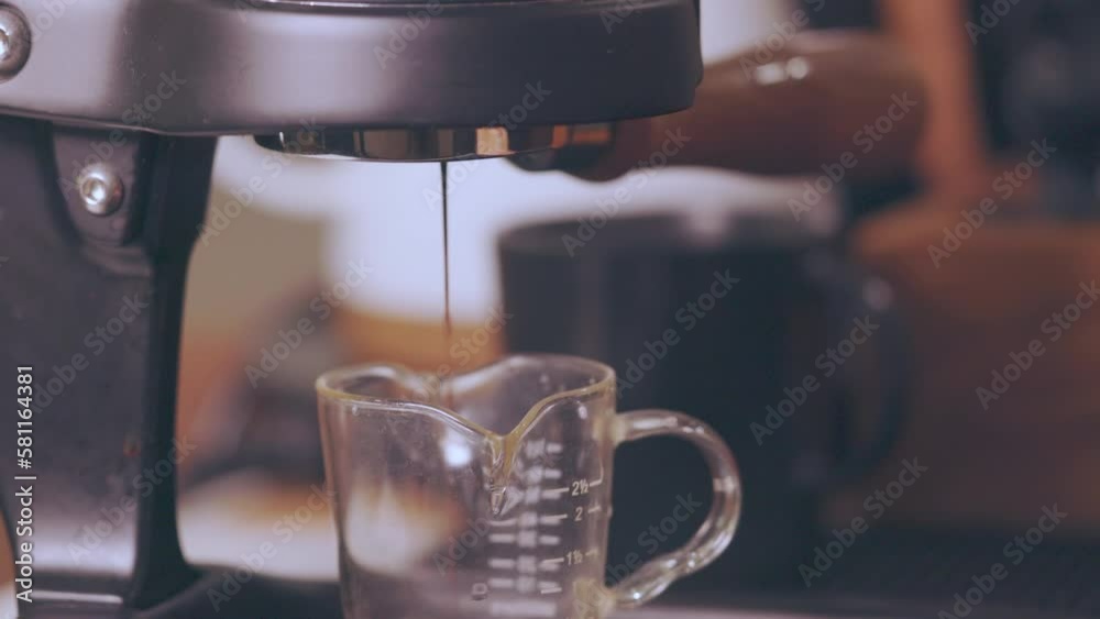 Close up slow motion 4K of beautiful coffee liquid flowing from coffee ...