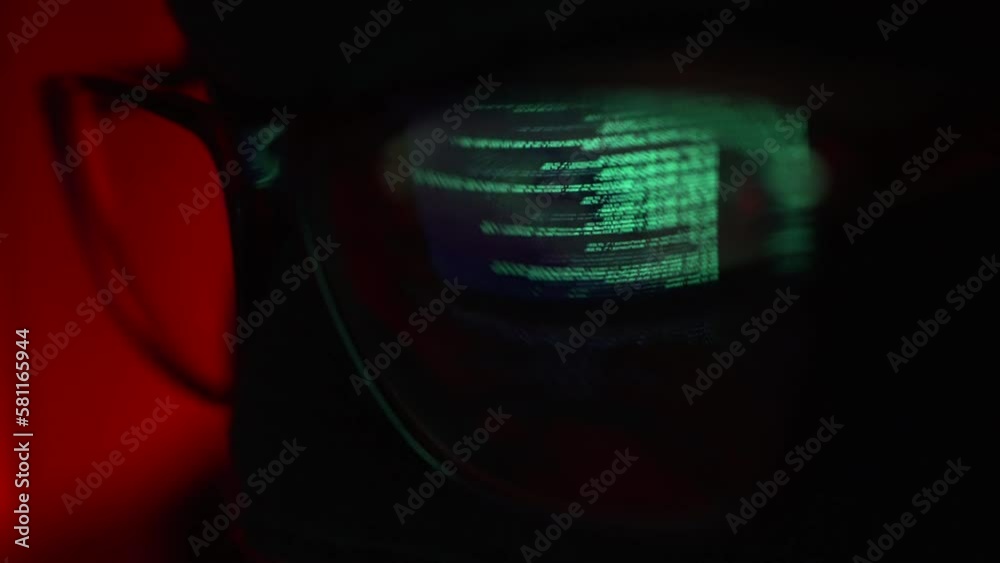 Hacker in a mask and glasses close-up tries to hack into the server ...