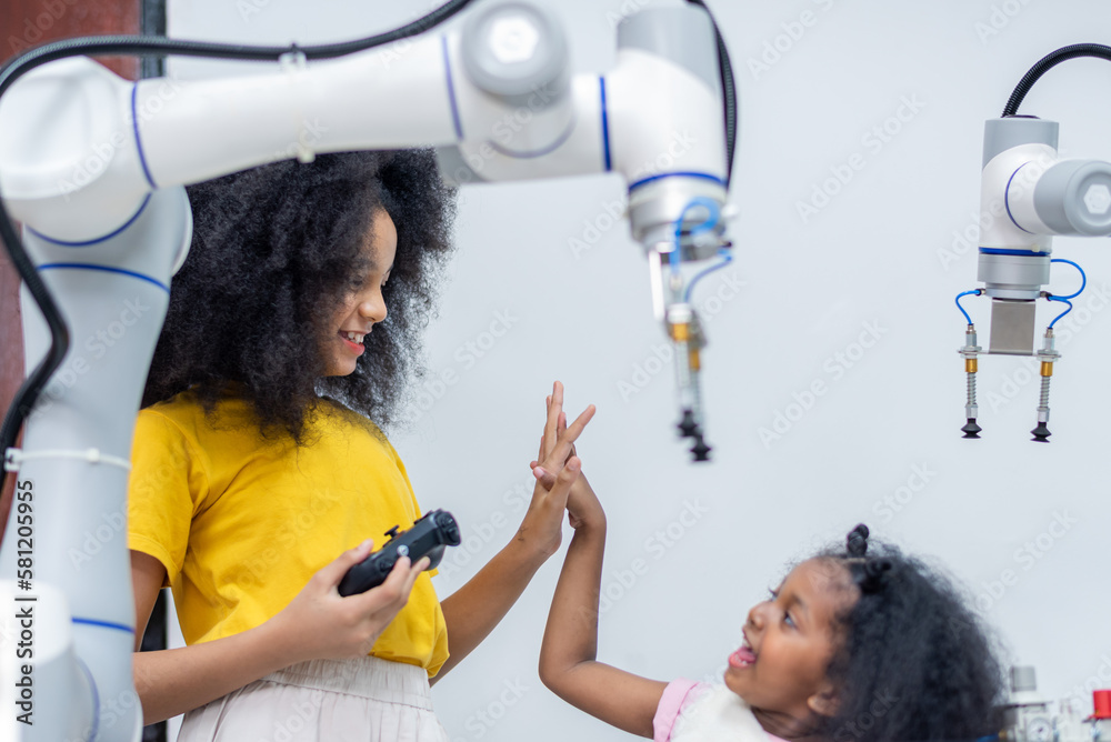 Kid female teen child enjoy Machine Learning Robot arm is Moving Under ...