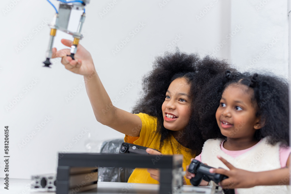Kid female teen child enjoy Machine Learning Robot arm is Moving Under ...