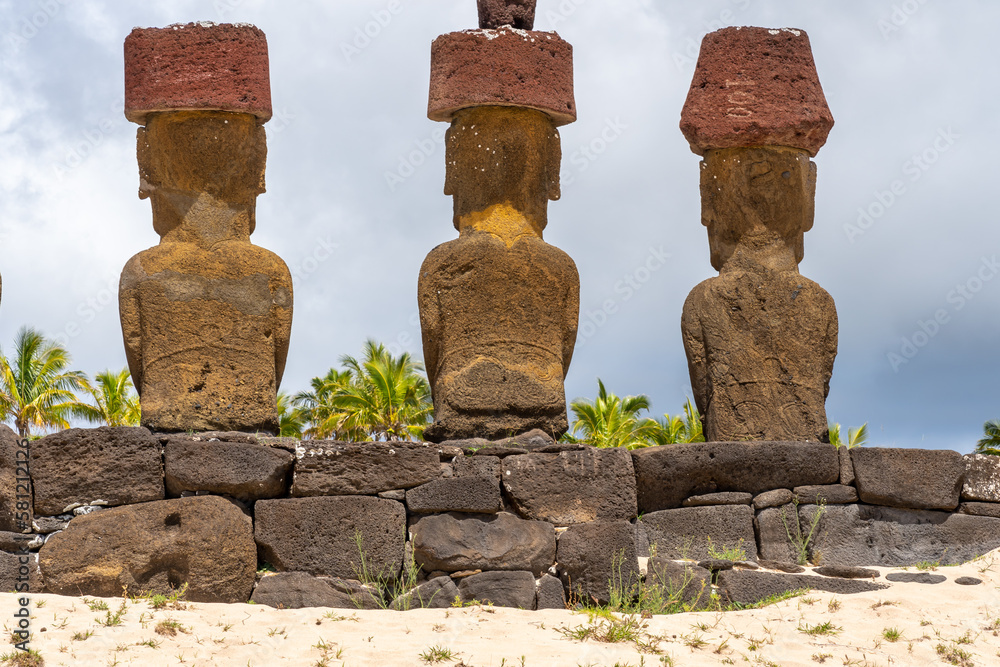 Back view of 3 of 7 moai statues of Ahu Nau Nau at Anakena Beach ...