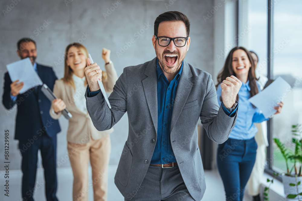 Euphoric excited business team celebrate corporate victory together in ...