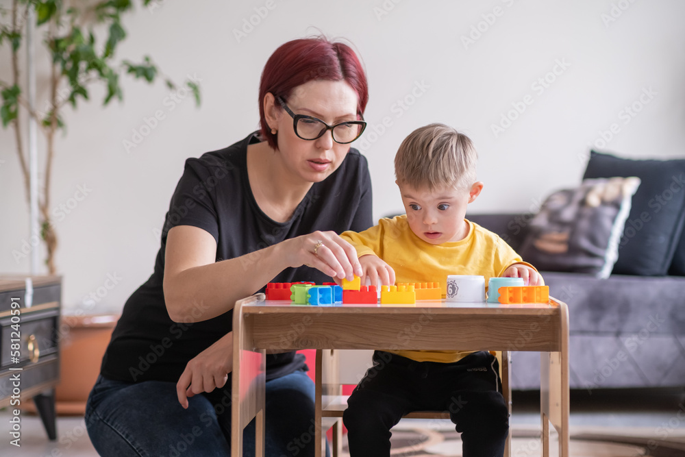 child living with Down syndrome learning and playing with educational ...