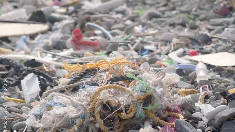 A beach filled with plastic waste and a garbage dump, highlighting the ...